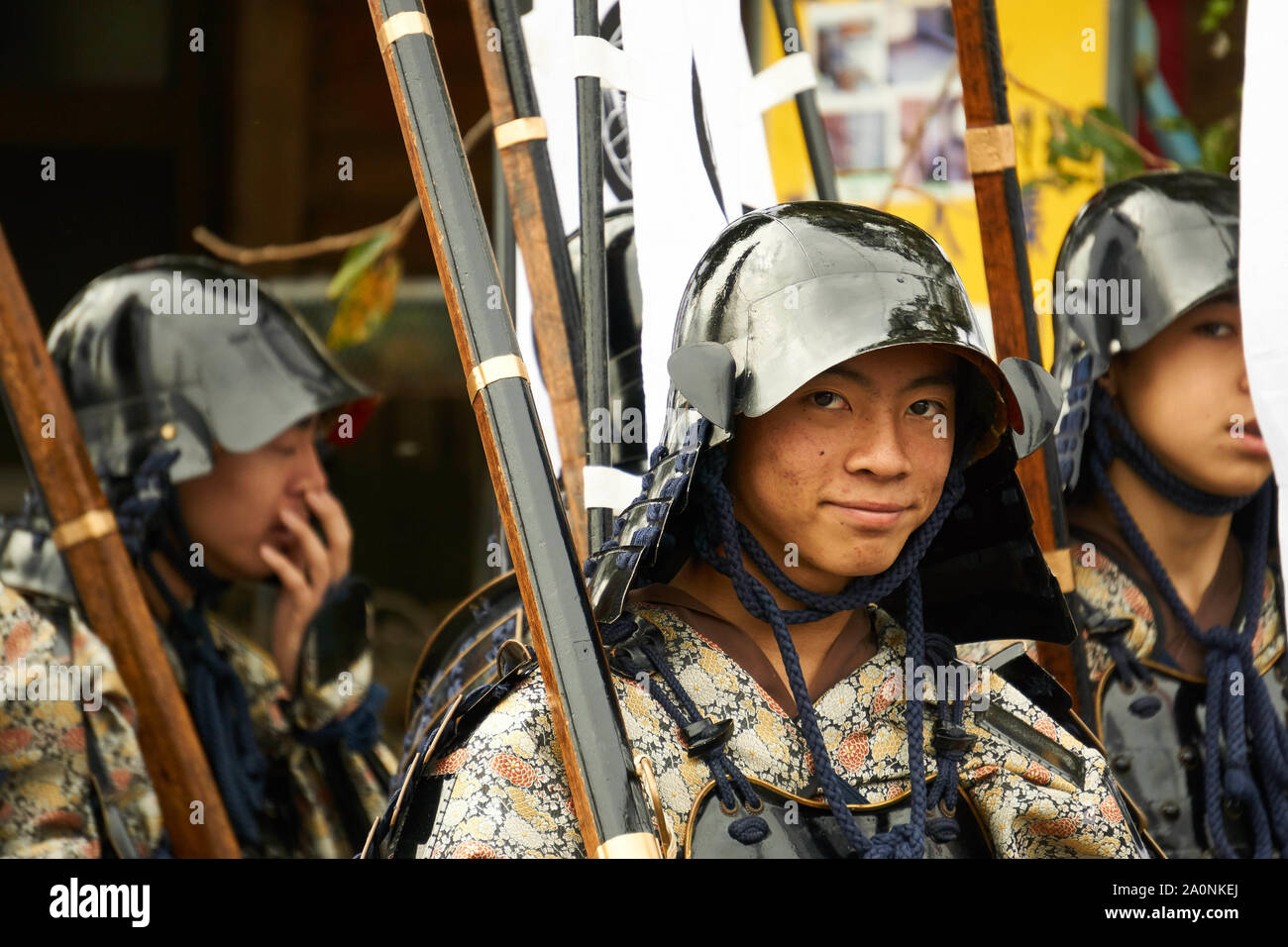 Smiling young Japanese reenactor dressed in traditional samurai costume ...