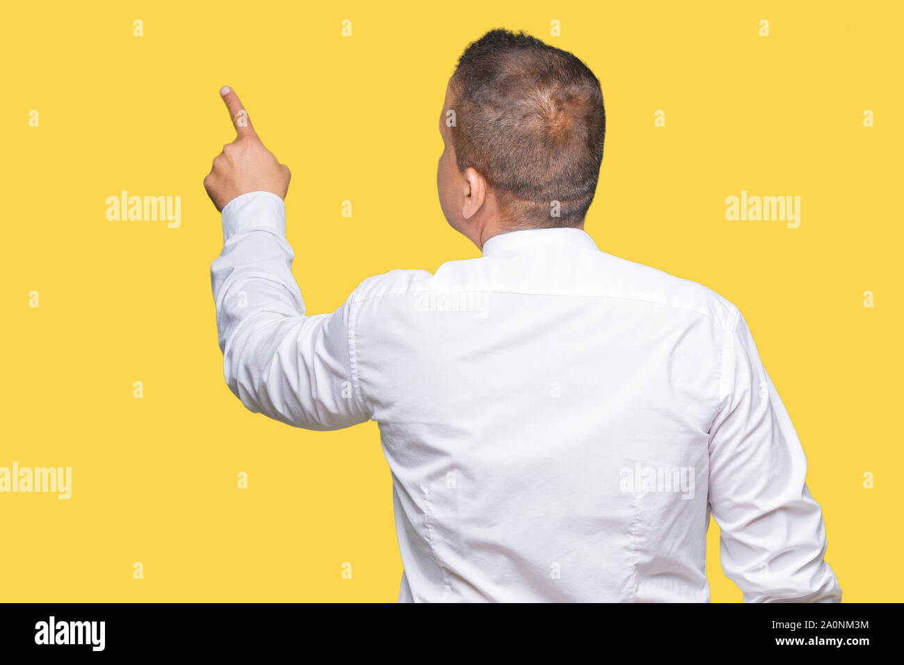 Middle age arab elegant man over isolated background Posing backwards ...