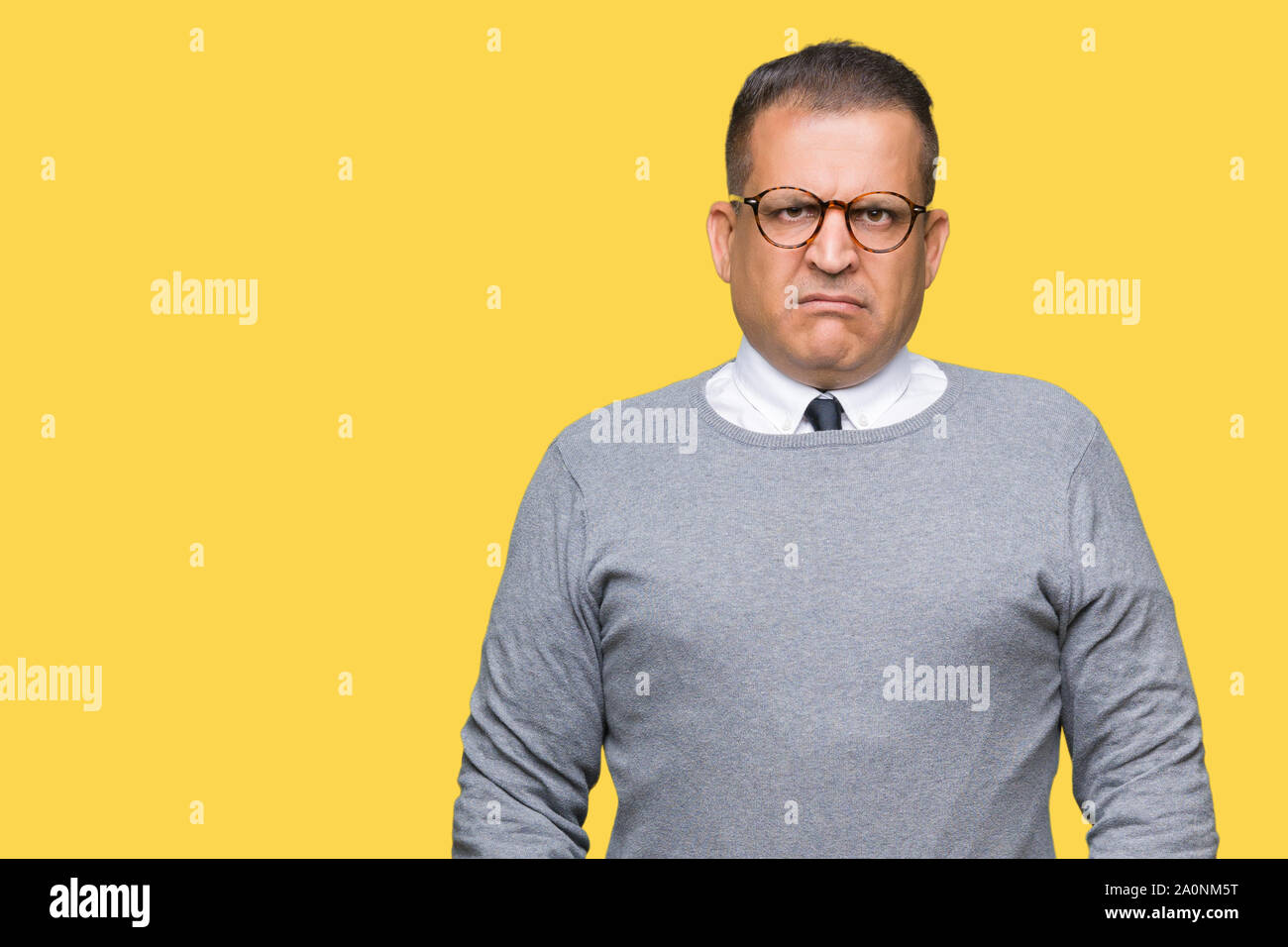 Middle age bussines arab man wearing glasses over isolated background ...
