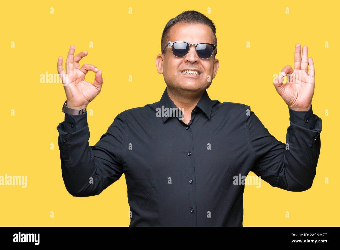 Middle age arab man wearing sunglasses over isolated background relax ...