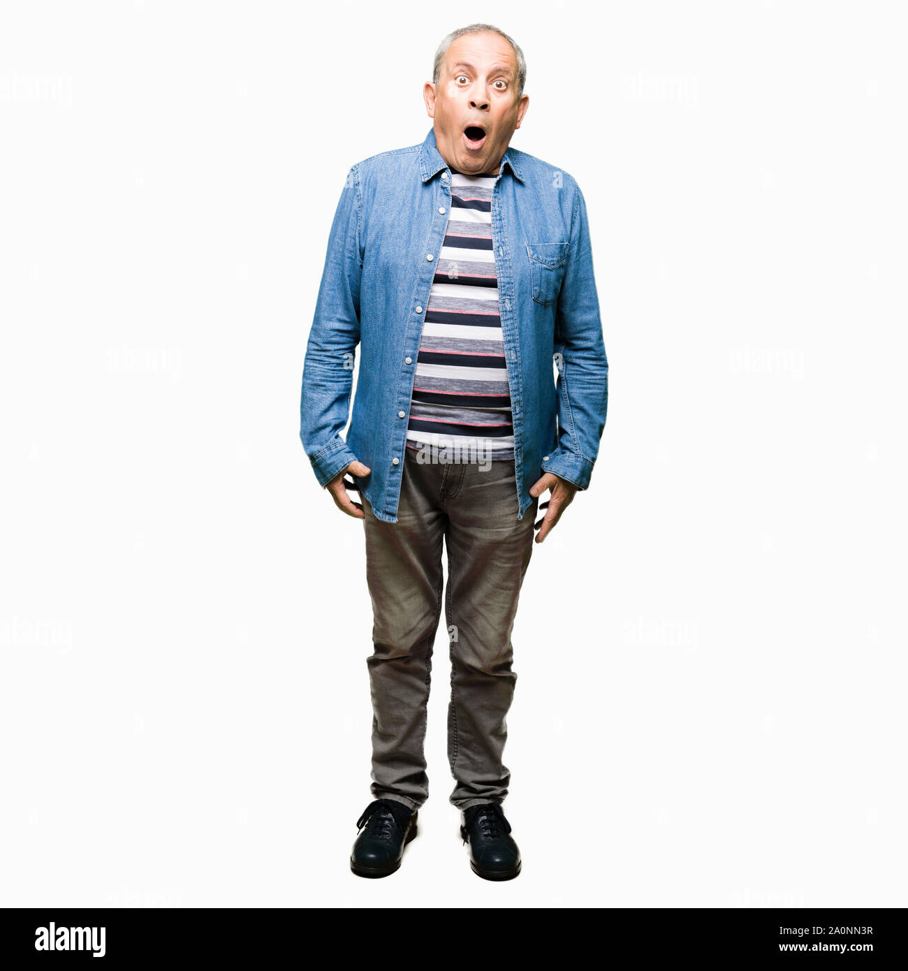 Handsome senior man wearing denim jacket afraid and shocked with ...