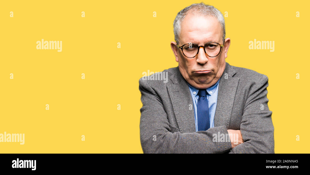 Handsome senior businesss man wearing glasses and tie skeptic and ...