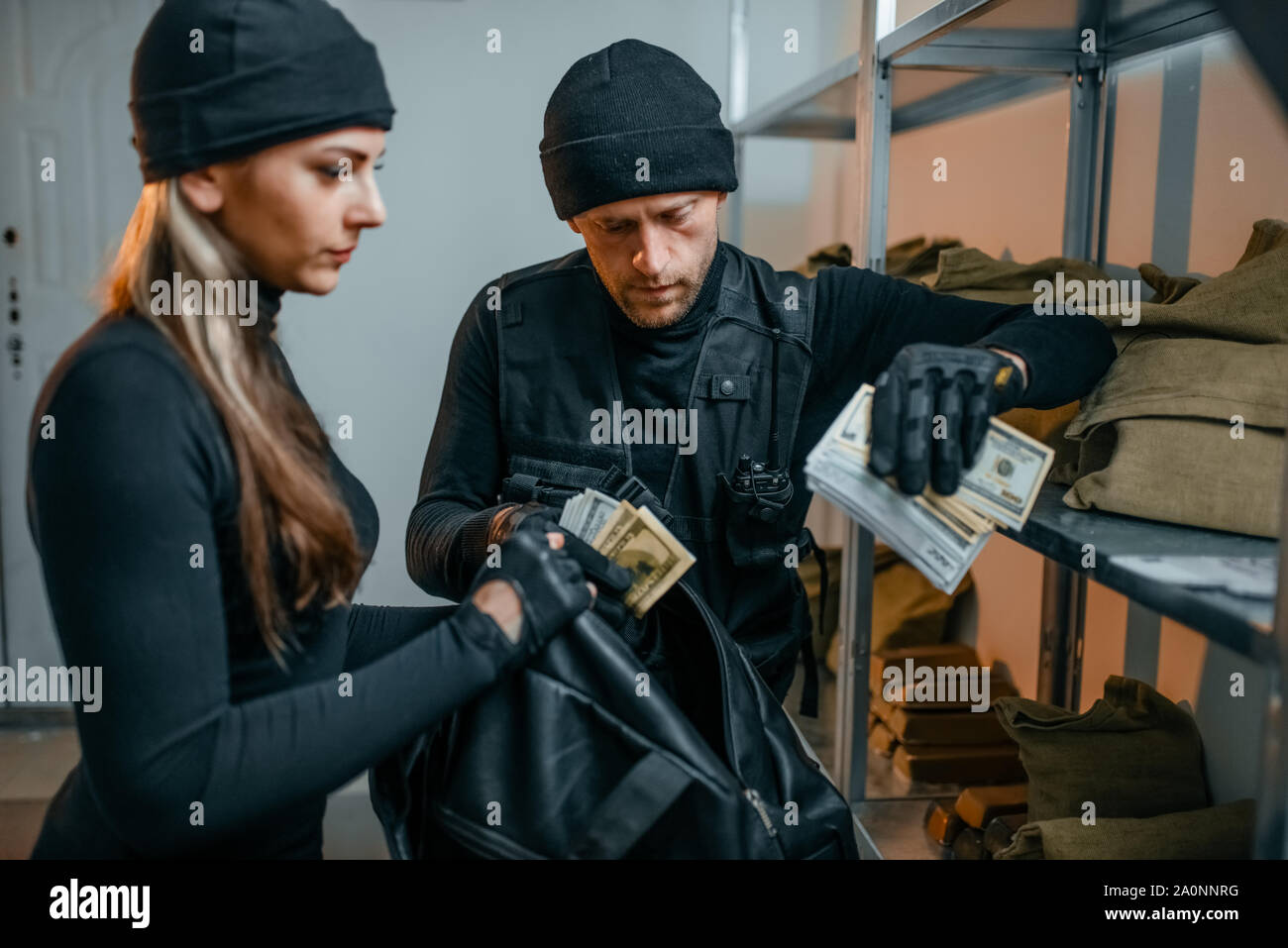 Robbers in black uniform steals money from vault Stock Photo - Alamy