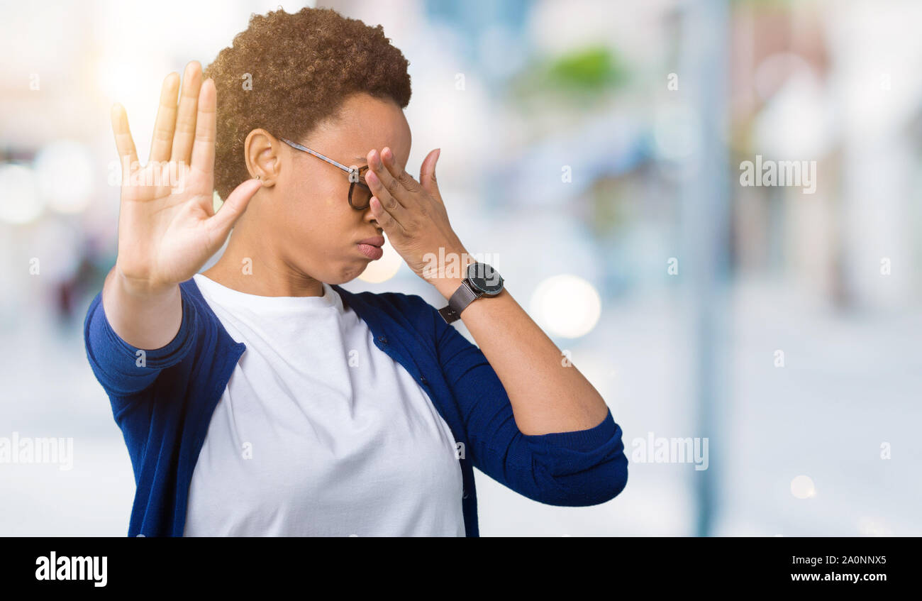 Young beautiful african american woman wearing glasses over isolated ...