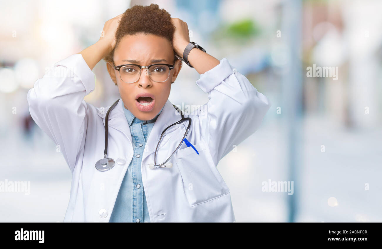 Young african american doctor woman wearing medical coat over isolated ...