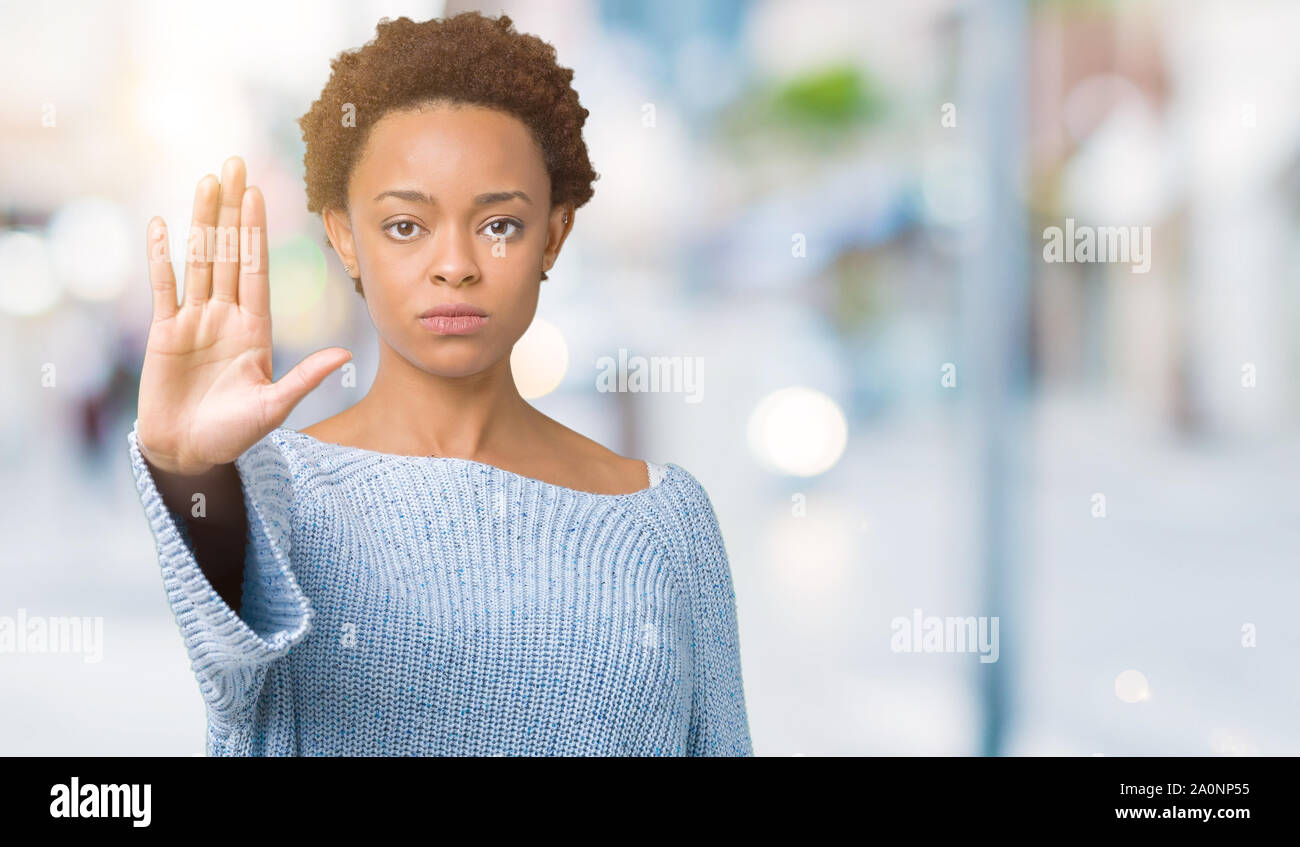 Young beautiful african american woman wearing a sweater over isolated ...