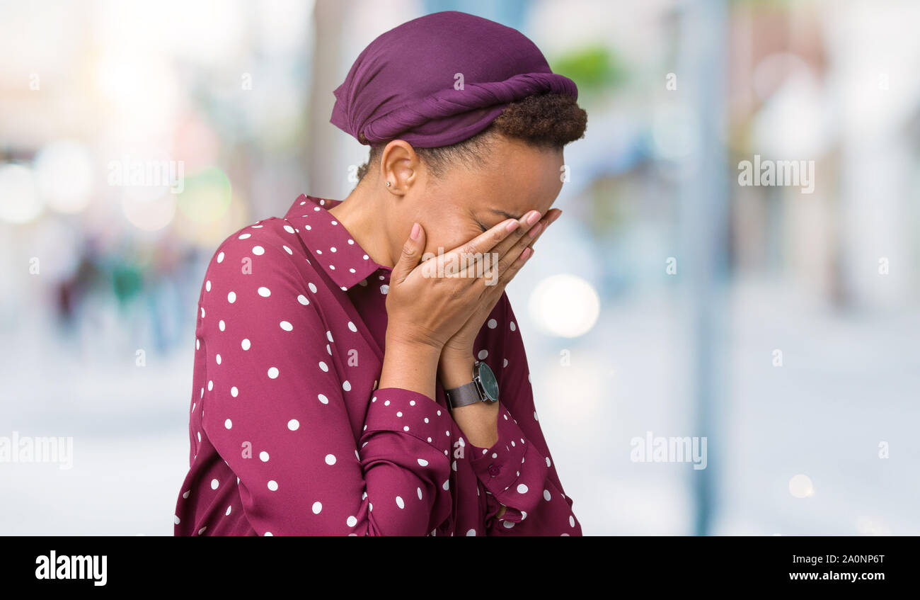 Beautiful young african american woman wearing head scarf over isolated ...