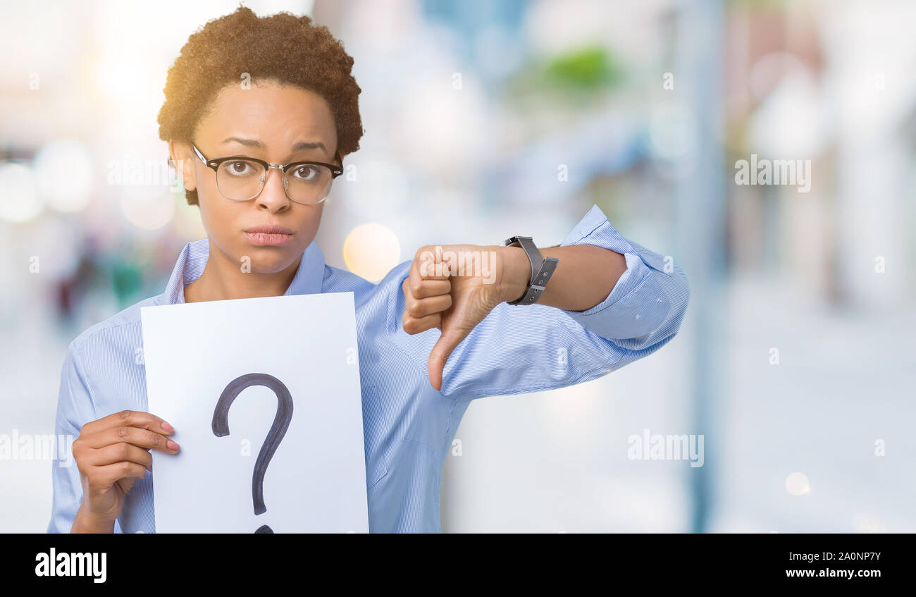 Young african american woman holding paper with question mark over ...