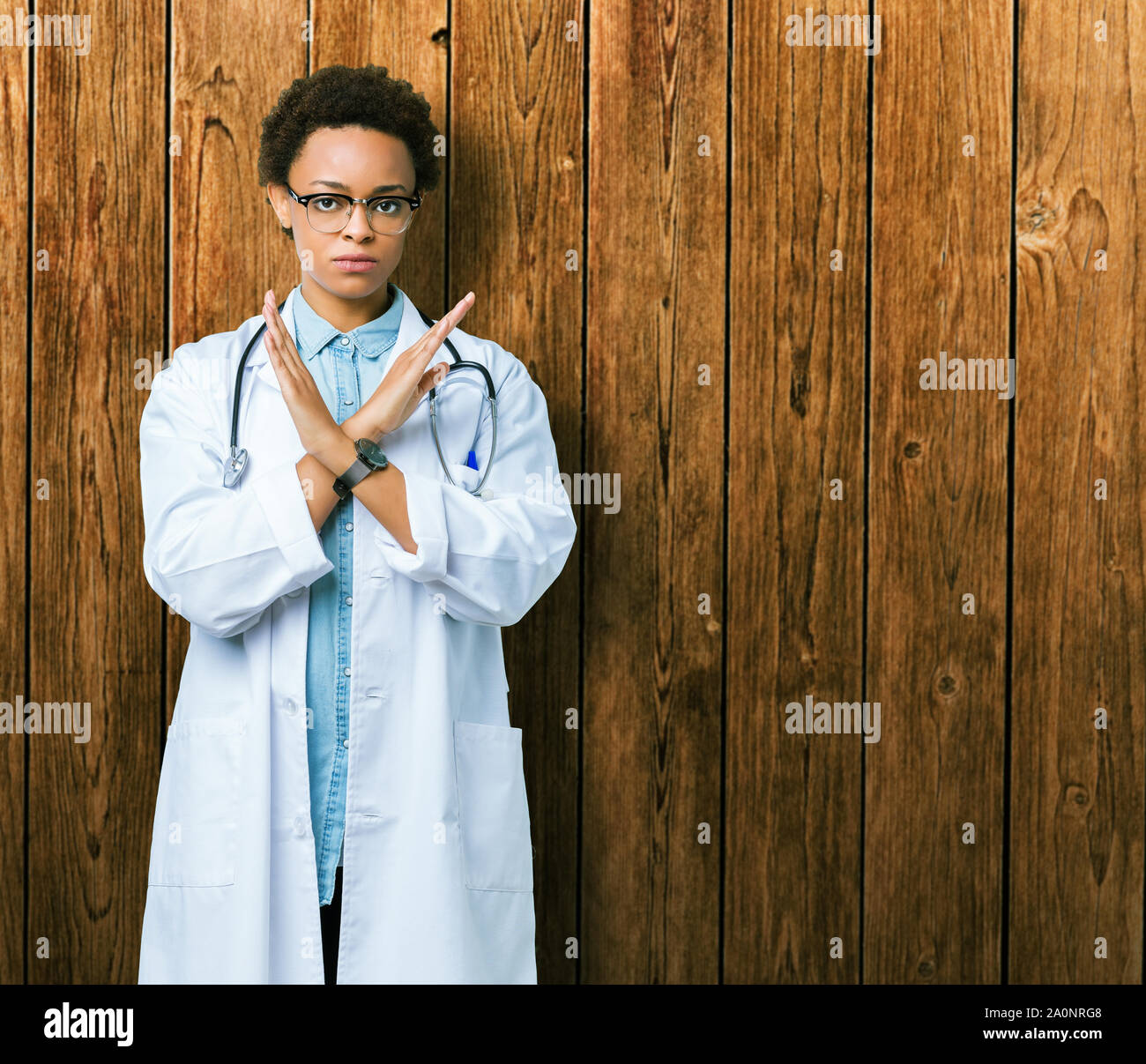 Young african american doctor woman wearing medical coat over isolated ...