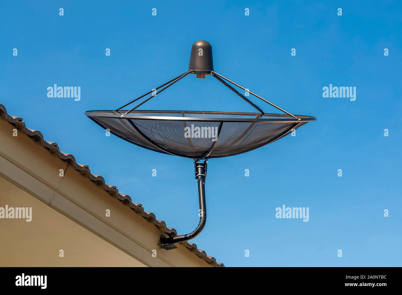 Satellite dish antenna on roof with blue sky background Stock Photo - Alamy