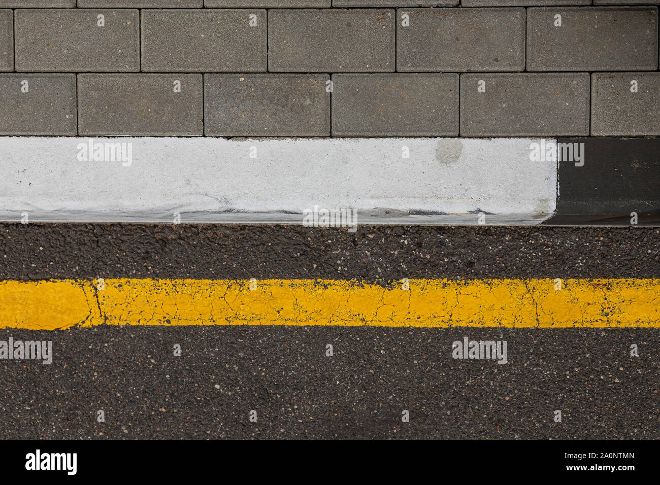 Yellow line of road marking along the walkway Stock Photo - Alamy