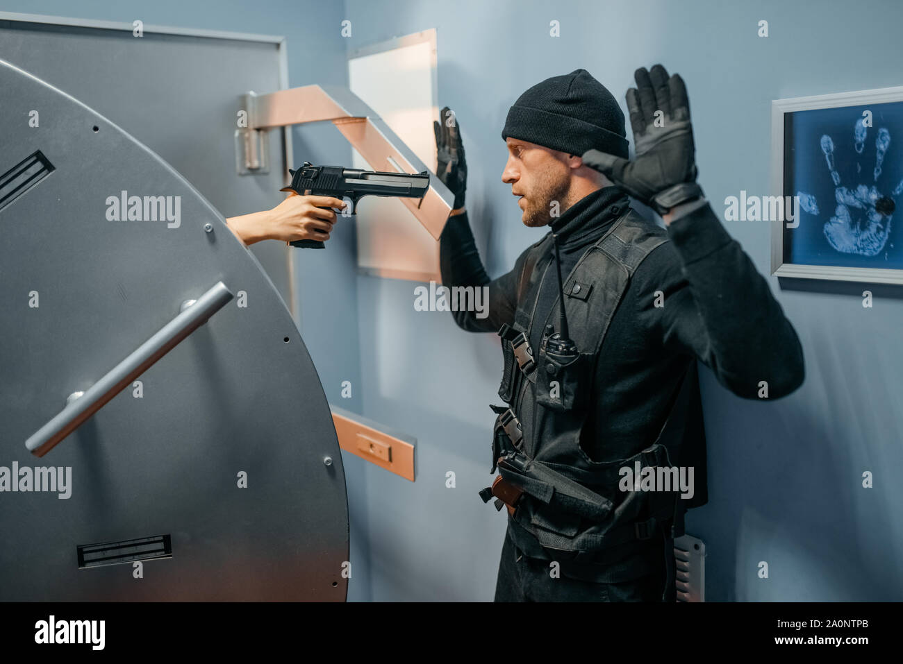 Robber standing at vault door with his hands up Stock Photo - Alamy