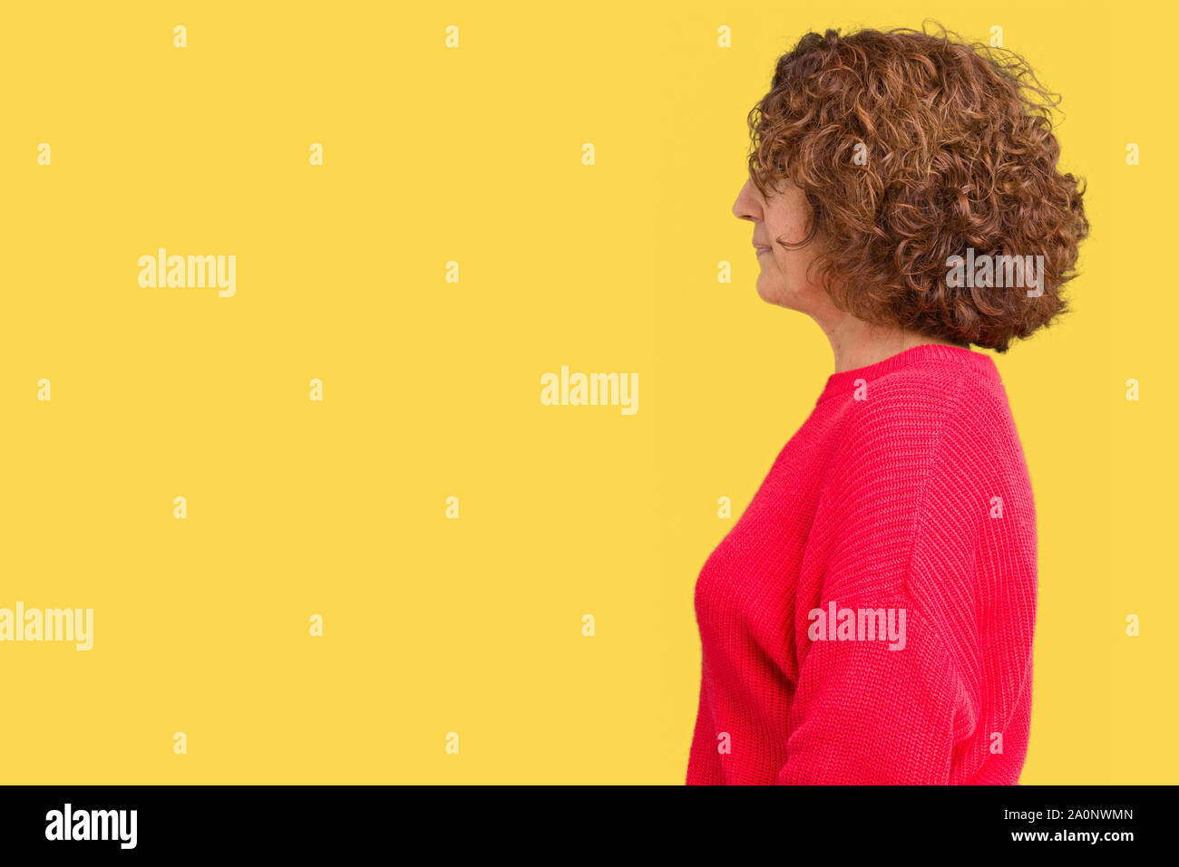 Beautiful middle ager senior woman red winter sweater over isolated ...