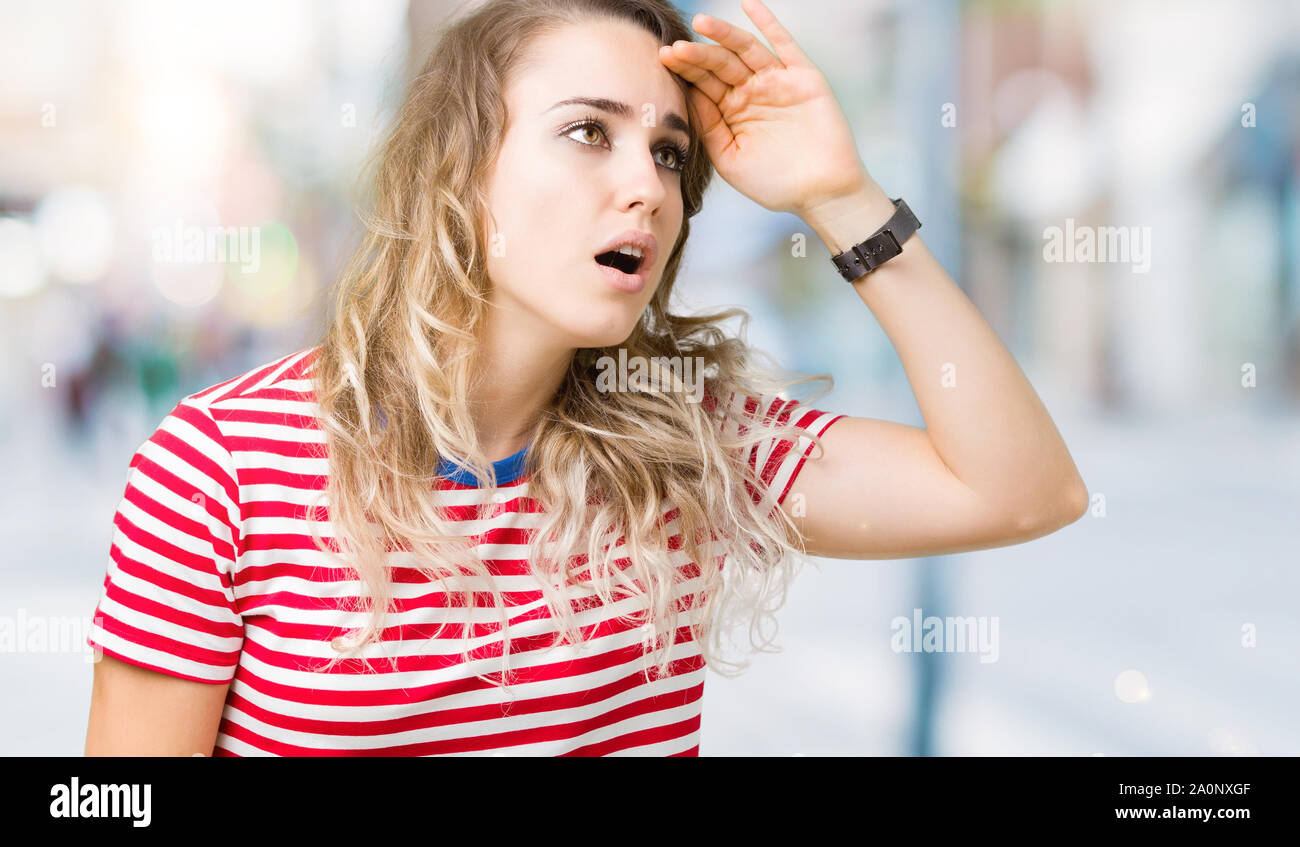 Beautiful young blonde woman over isolated background very happy and ...