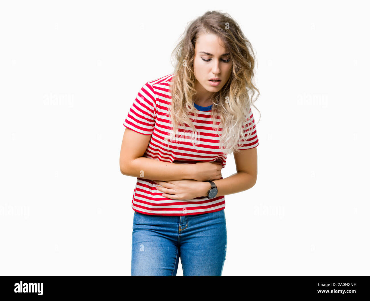 Beautiful young blonde woman over isolated background with hand on ...