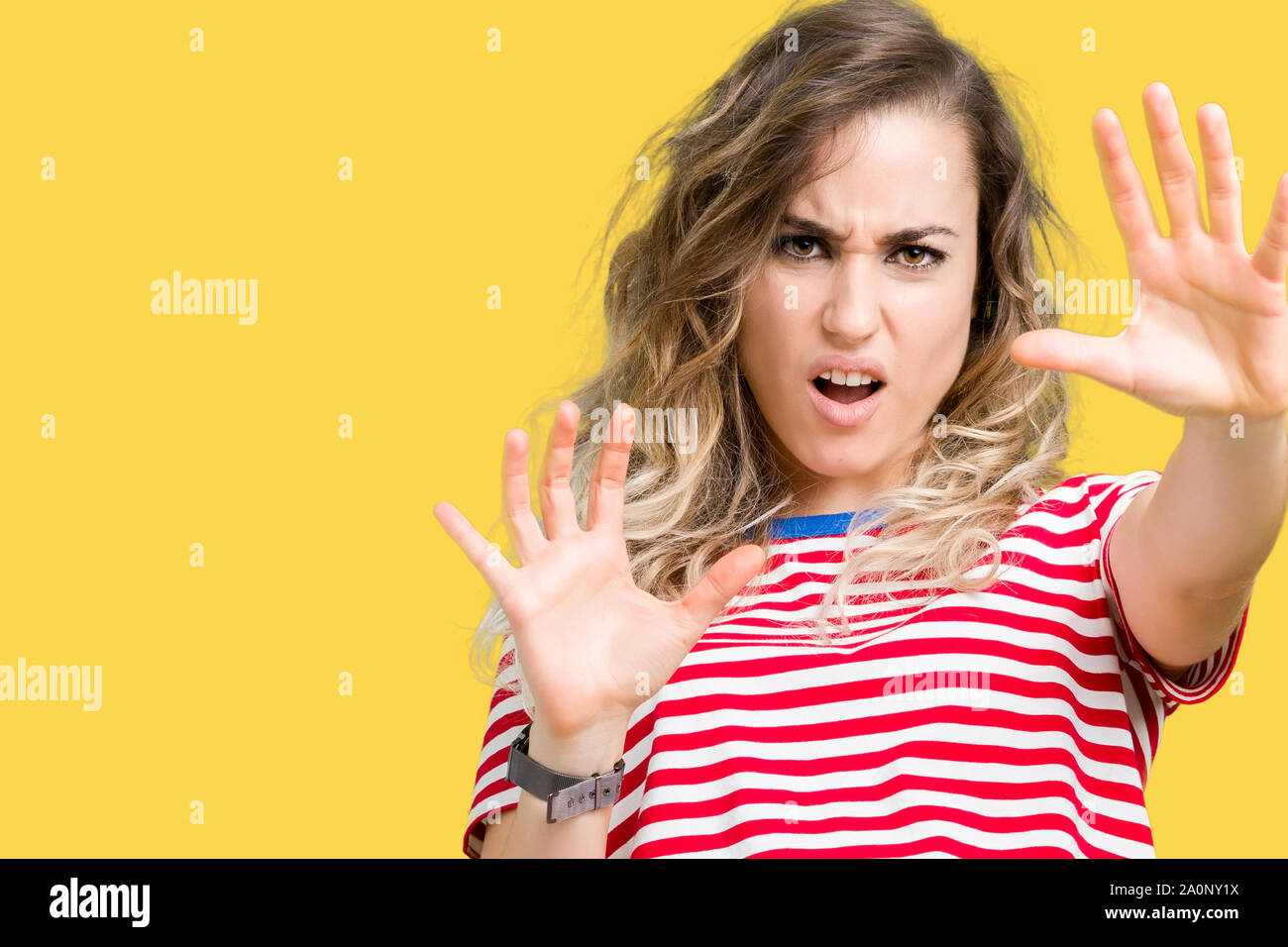 Beautiful young blonde woman over isolated background afraid and ...