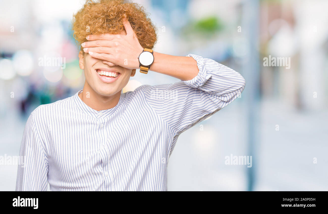 Young handsome business man with afro hair wearing elegant shirt ...