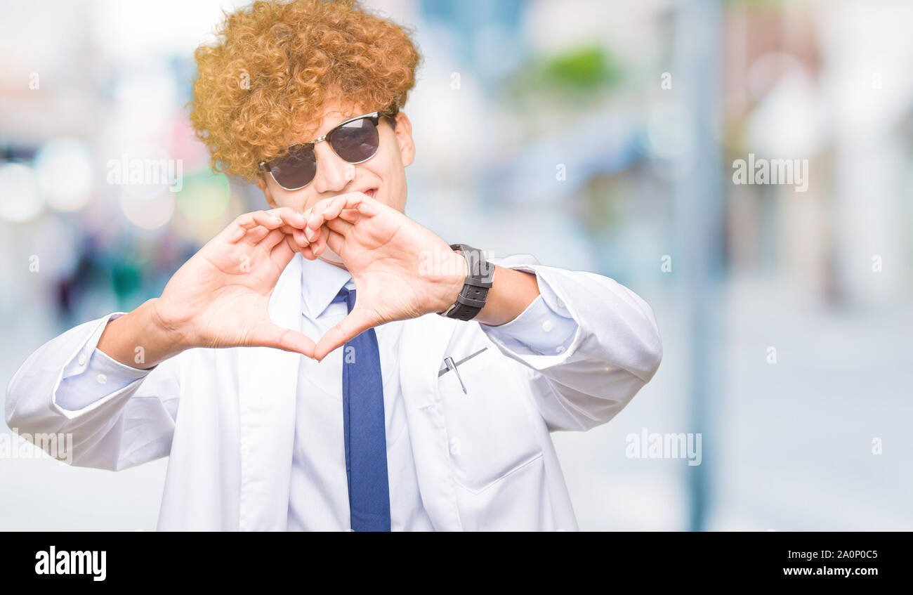 Young handsome scientist man wearing professional coat and sunglasses ...