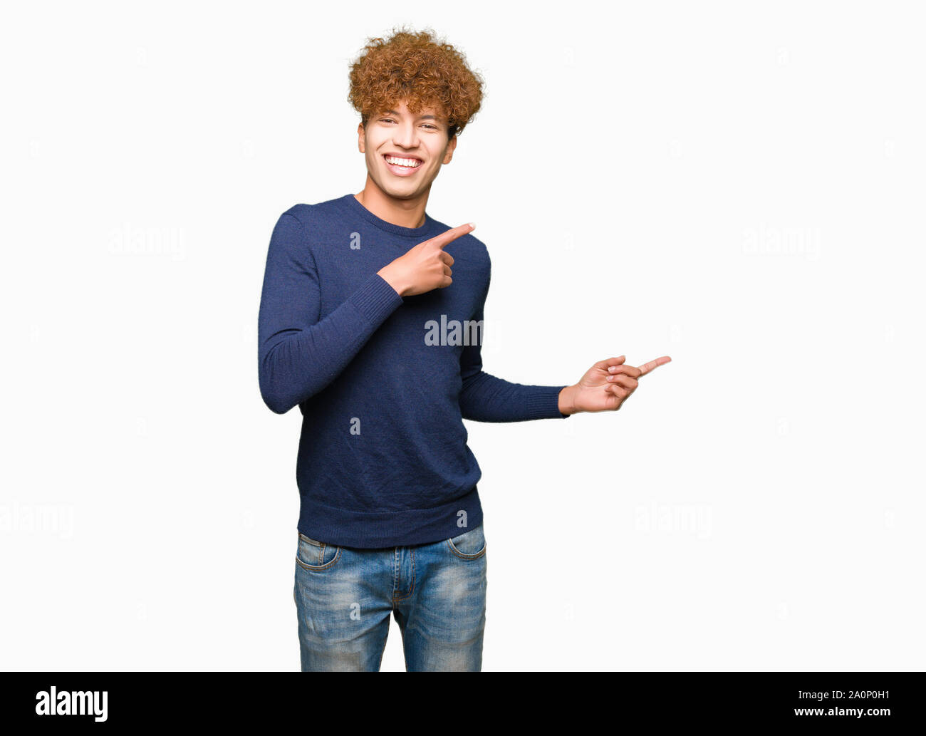 Young handsome man with afro hair smiling and looking at the camera ...