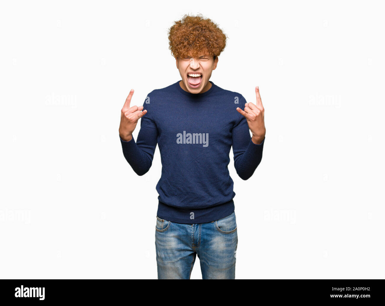 Young handsome man with afro hair shouting with crazy expression doing ...