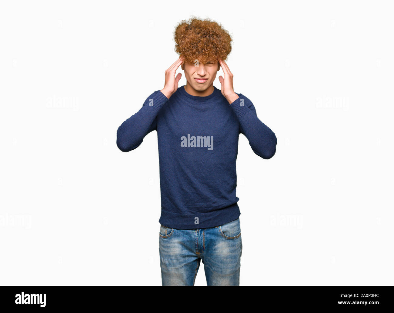 Young handsome man with afro hair with hand on head for pain in head ...