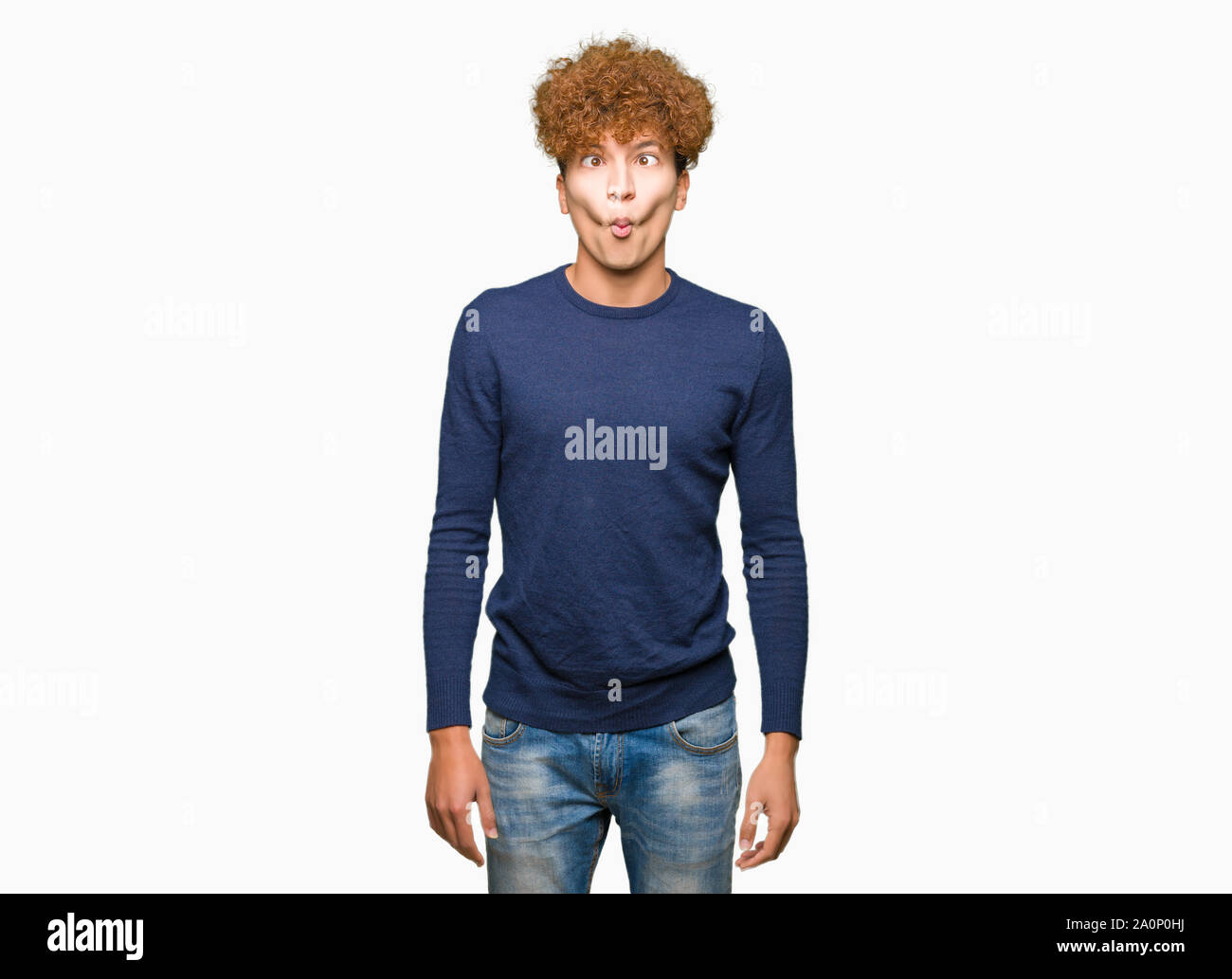 Young handsome man with afro hair making fish face with lips, crazy and ...