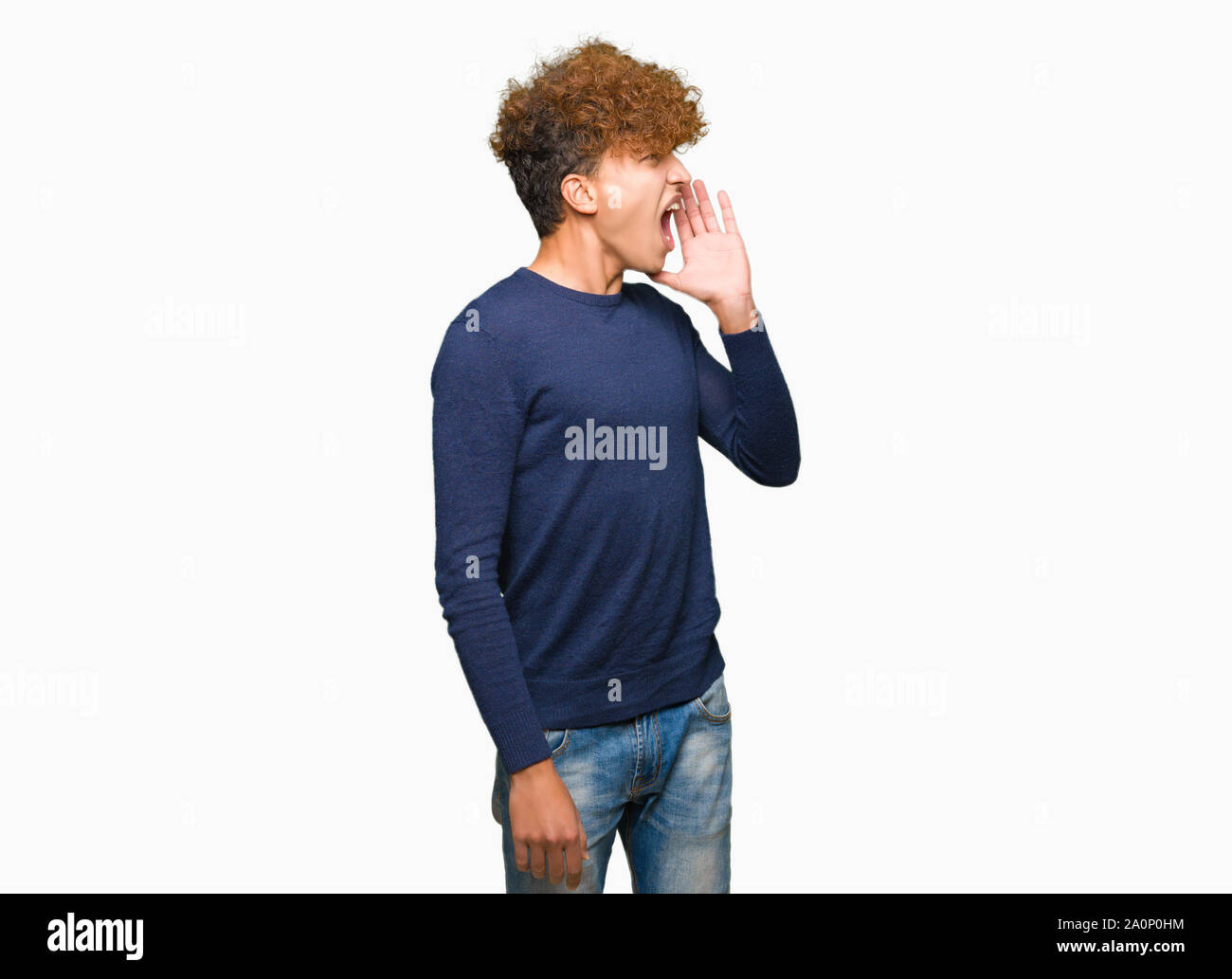 Young handsome man with afro hair shouting and screaming loud to side ...