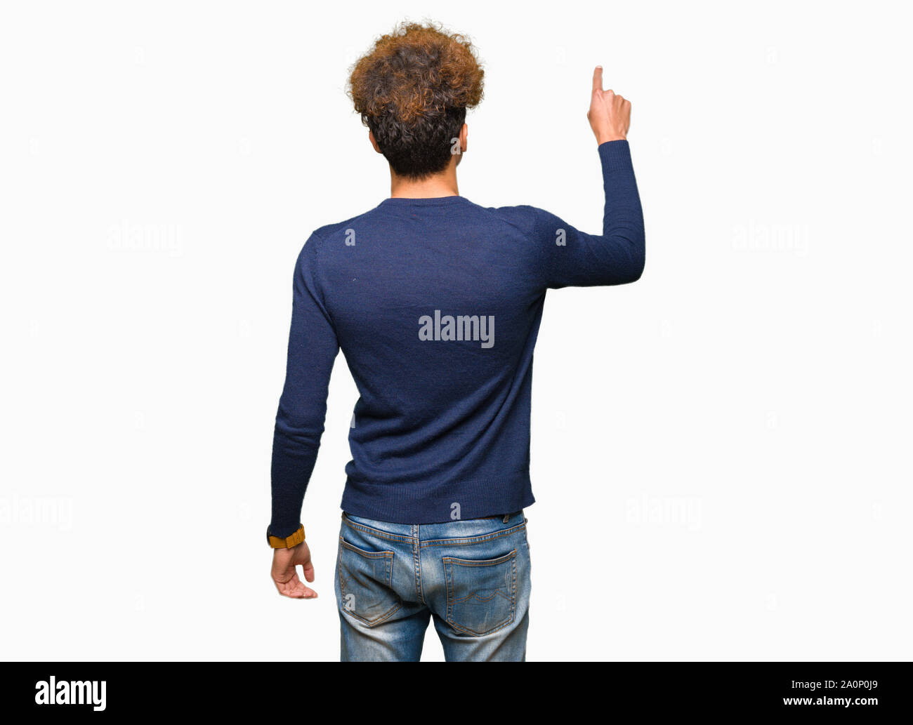 Young handsome man with afro hair Posing backwards pointing behind with ...