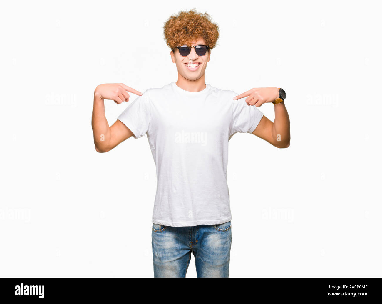 Young handsome man with afro hair wearing sunglasses looking confident ...