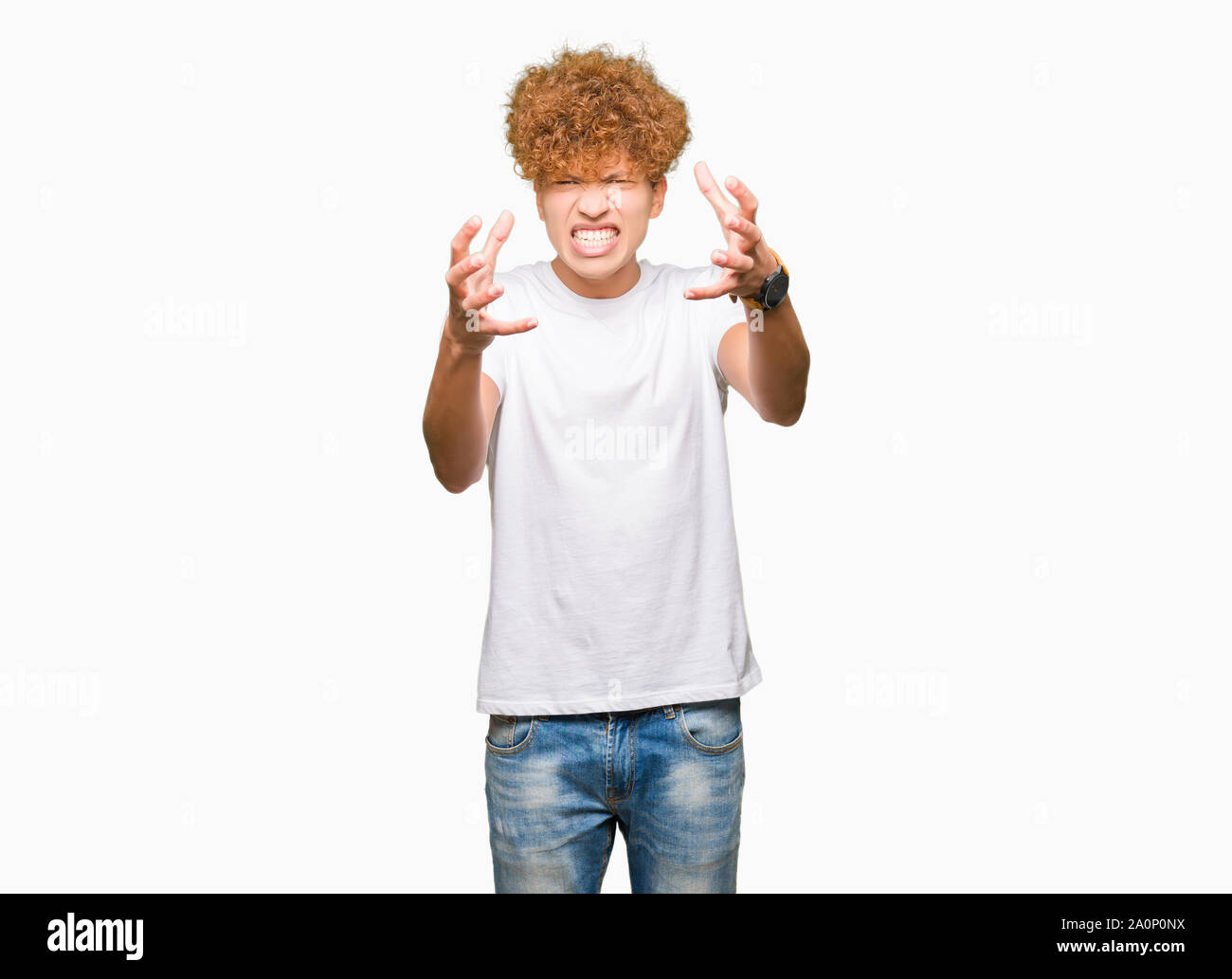 Young handsome man with afro hair wearing casual white t-shirt Shouting ...