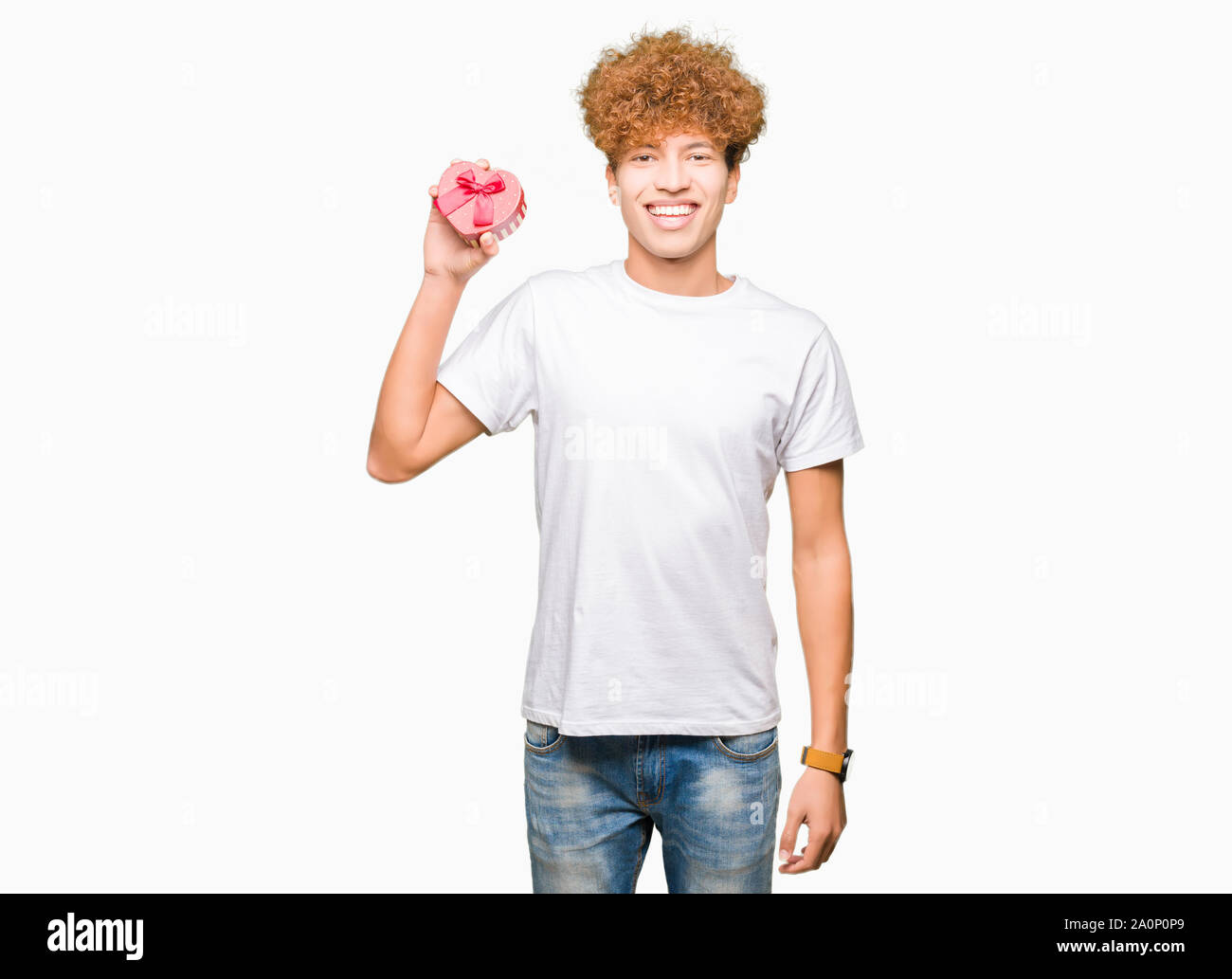 Young handsome man holding heart box as gift of valentine's day with a ...