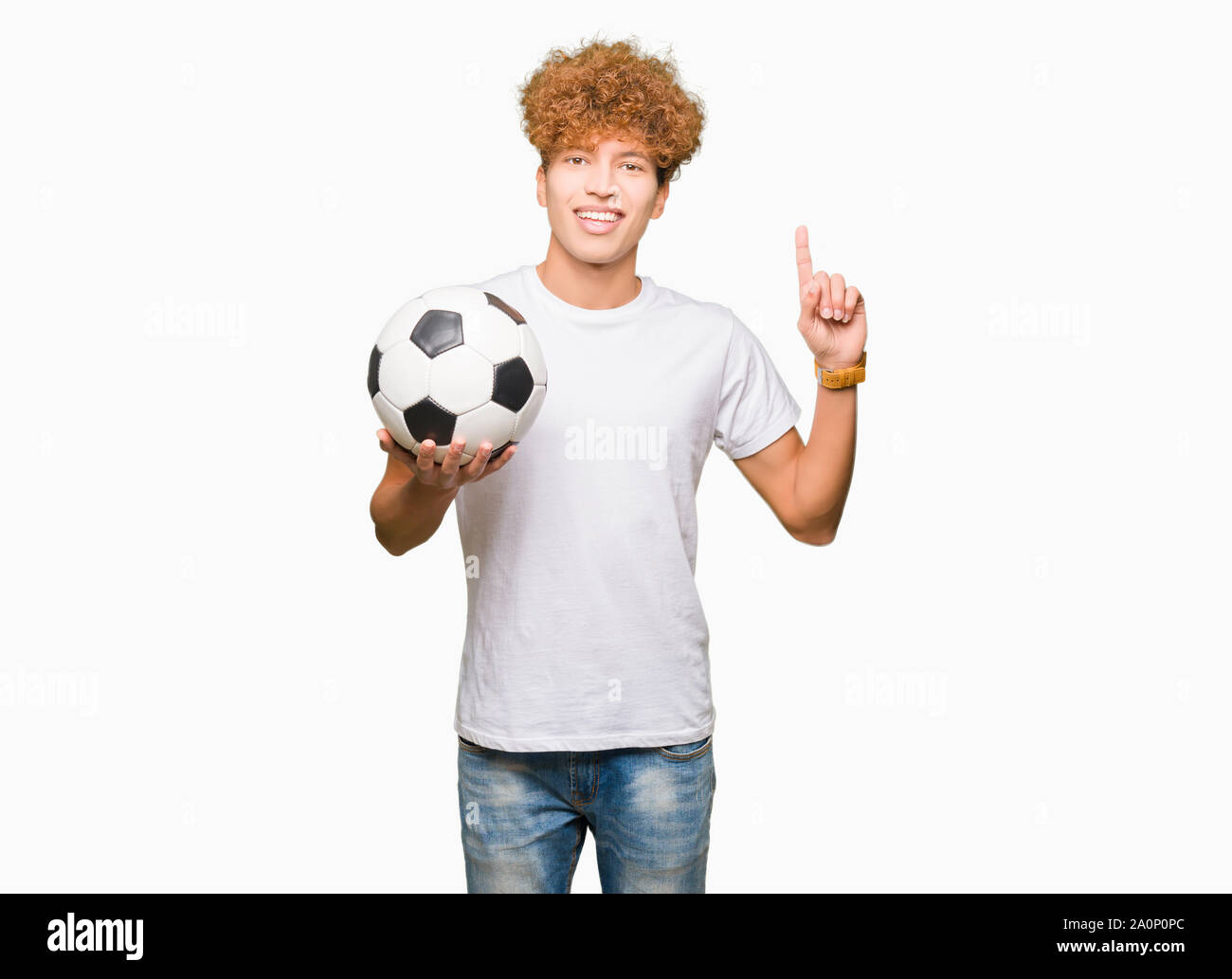 Young handsome man holding soccer football ball surprised with an idea ...