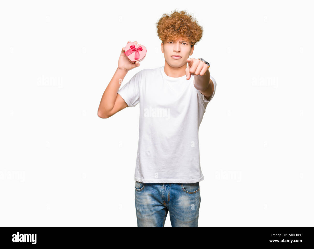 Young handsome man holding heart box as gift of valentine's day ...