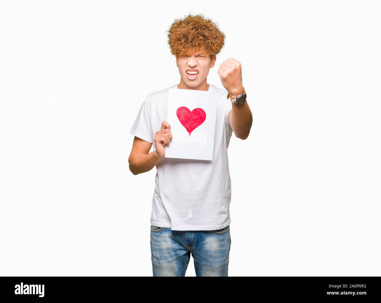 Young handsome man holding paper with red heart annoyed and frustrated ...