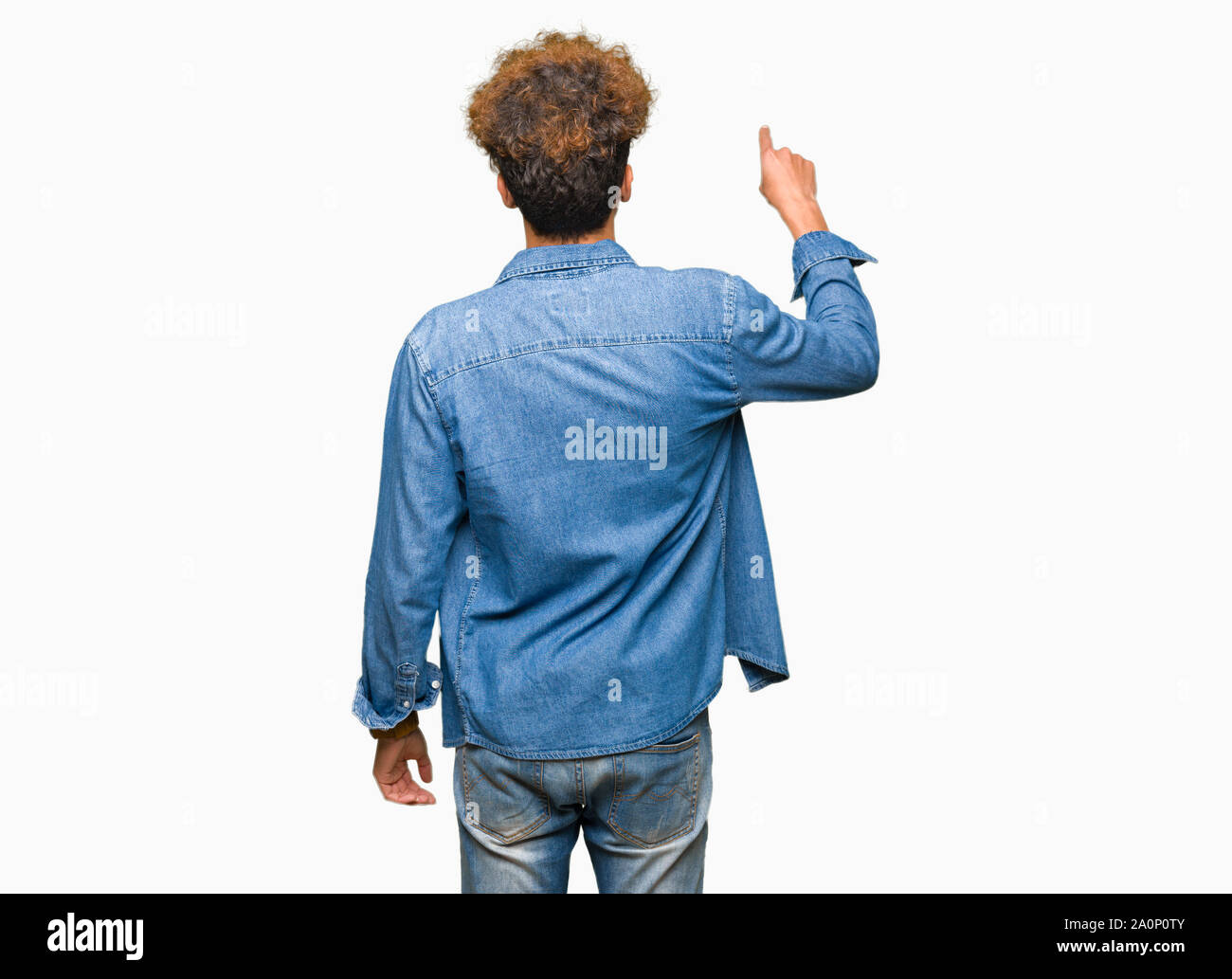 Young handsome man with afro hair wearing denim jacket Posing backwards ...