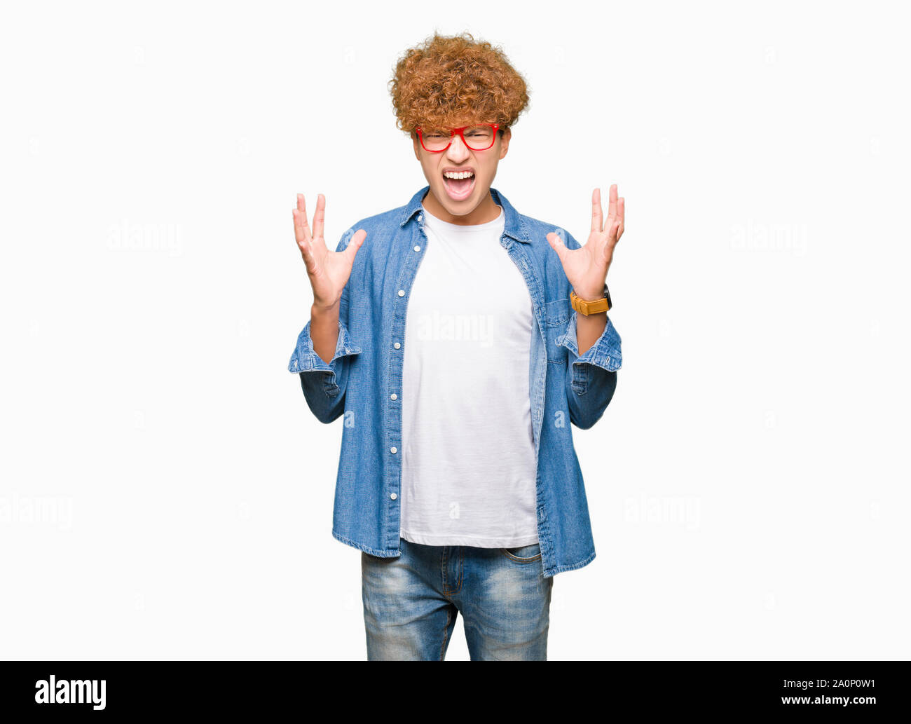 Young handsome man with afro hair wearing glasses crazy and mad ...
