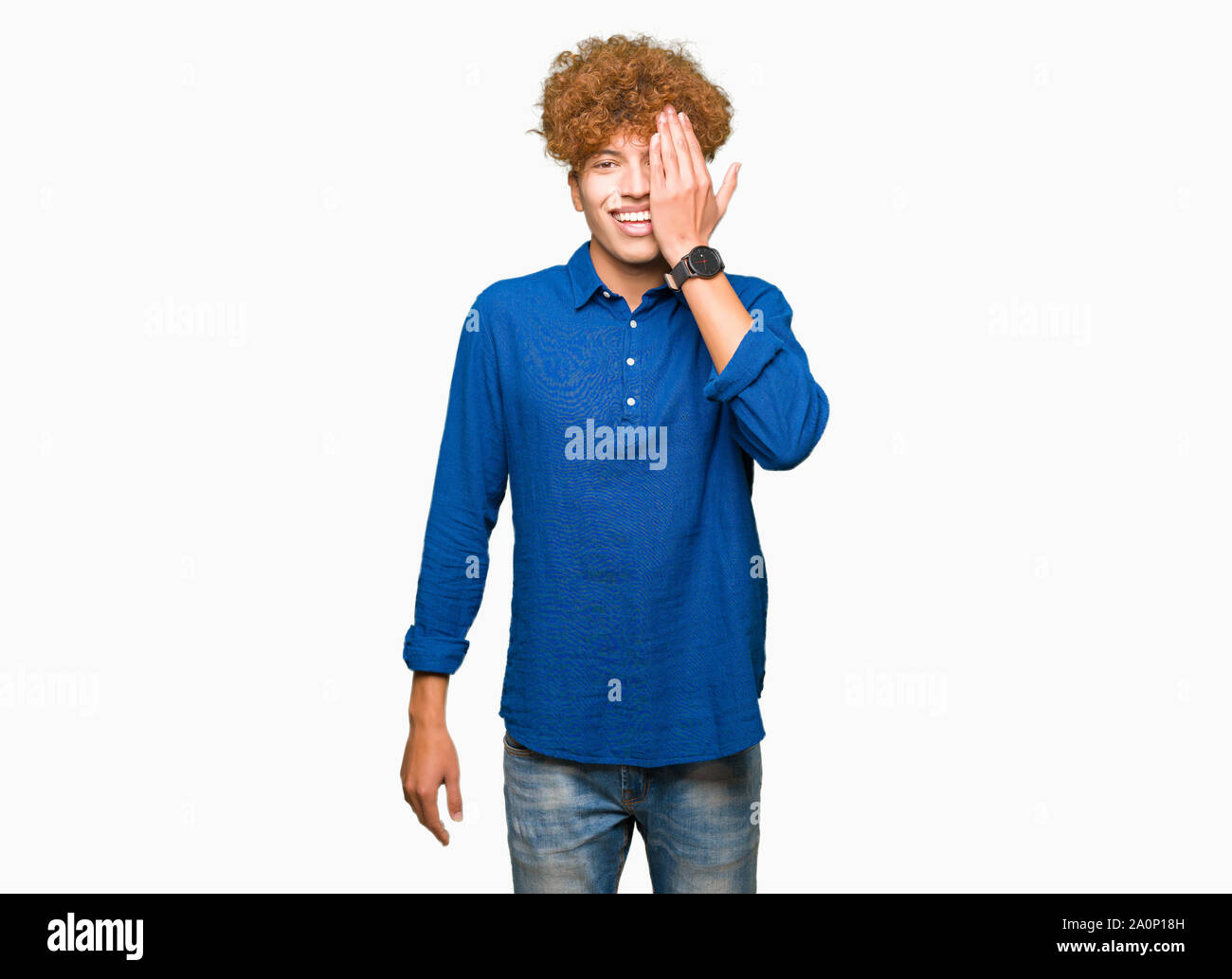 Young handsome elegant man with afro hair covering one eye with hand ...