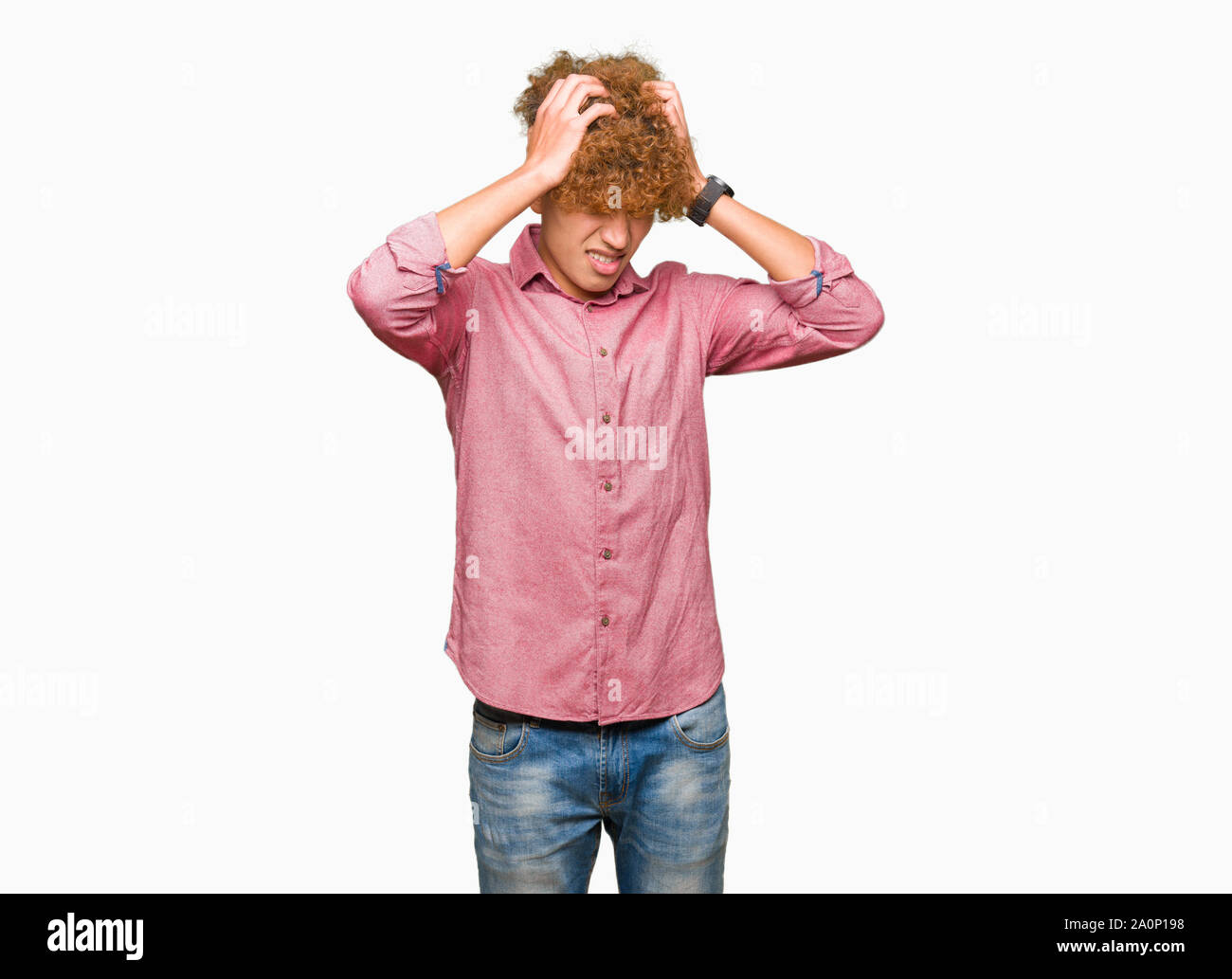 Young handsome business man with afro hair suffering from headache ...