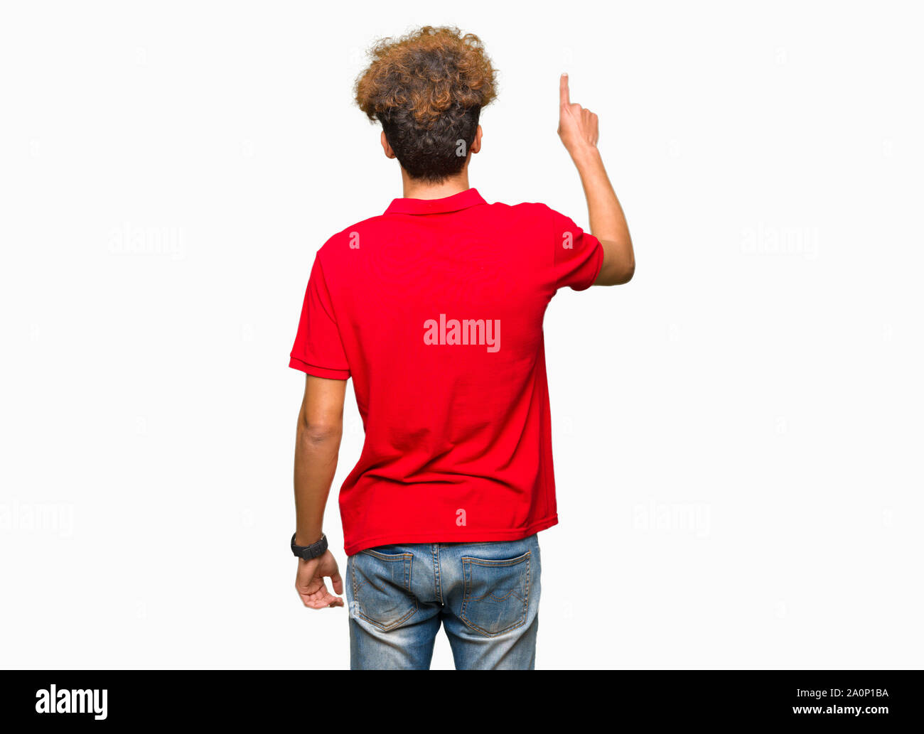Young handsome man with afro hair wearing red t-shirt Posing backwards ...
