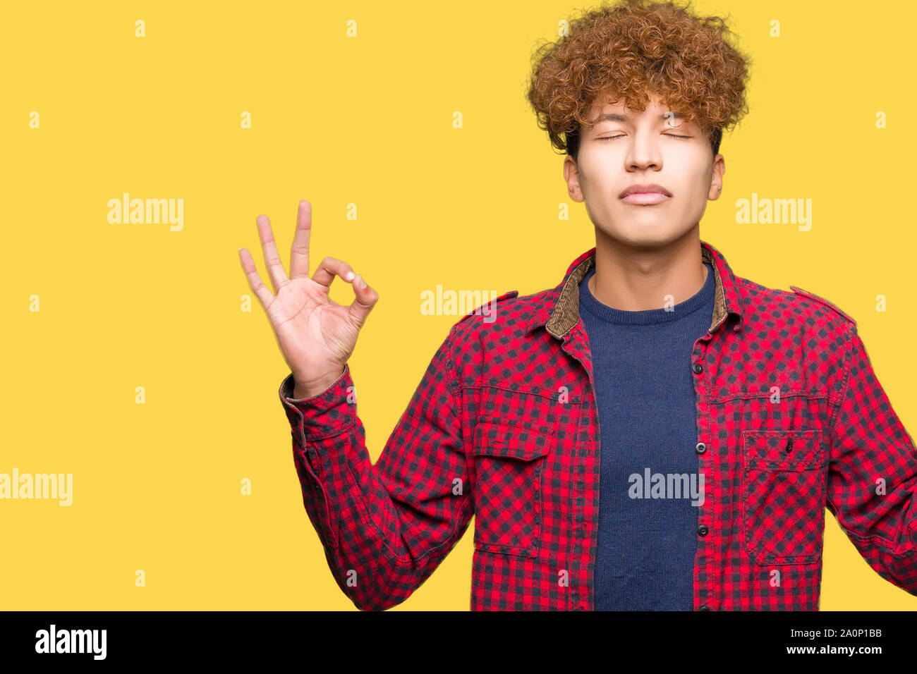 Young handsome student man with afro hair wearing a jacket relax and ...