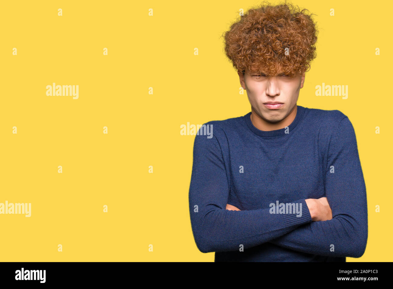 Young handsome man with afro hair skeptic and nervous, disapproving ...