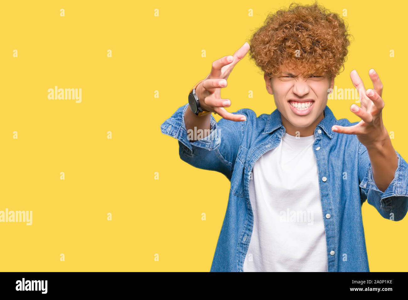 Young handsome man with afro hair wearing denim jacket Shouting ...