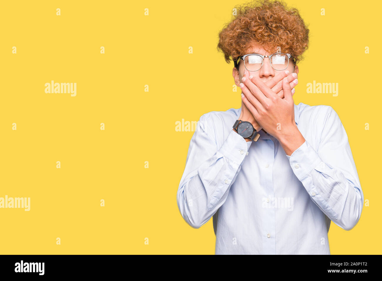 Young handsome business man with afro wearing glasses shocked covering ...