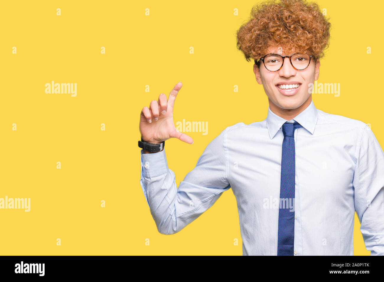 Young handsome business man with afro wearing glasses smiling and ...