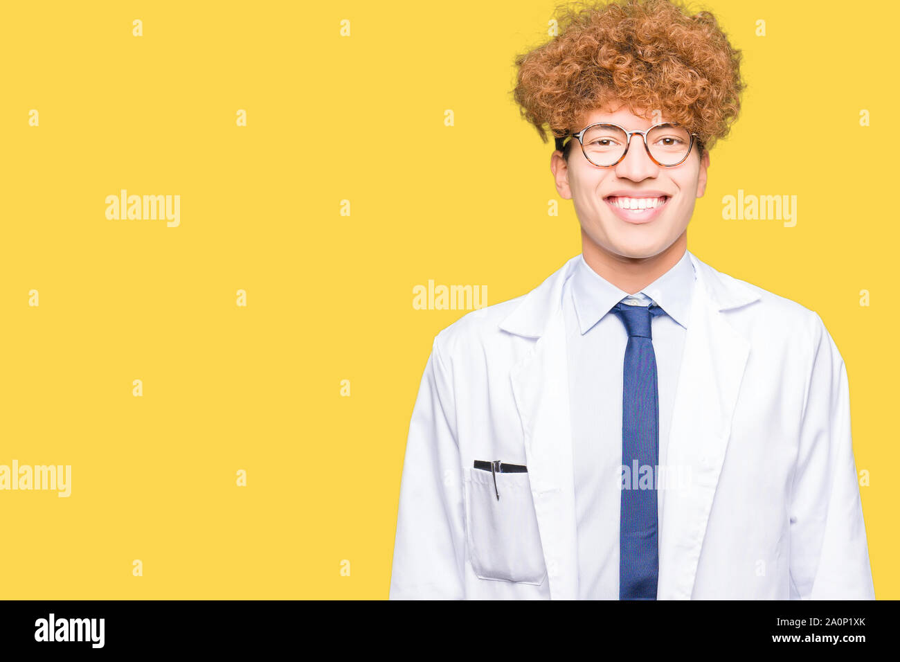 Young handsome scientist man wearing glasses with a happy and cool ...
