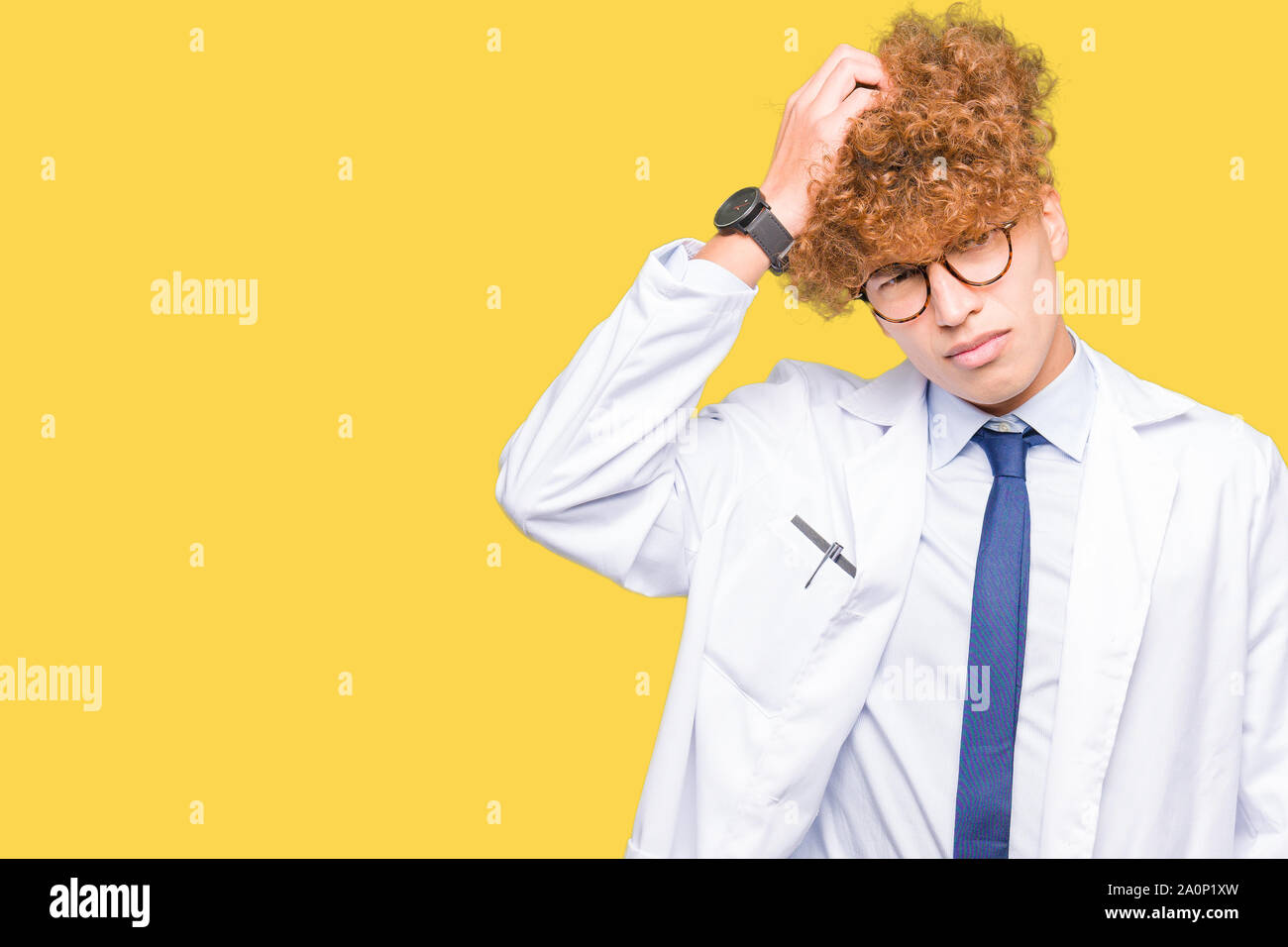 Young handsome scientist man wearing glasses confuse and wonder about ...