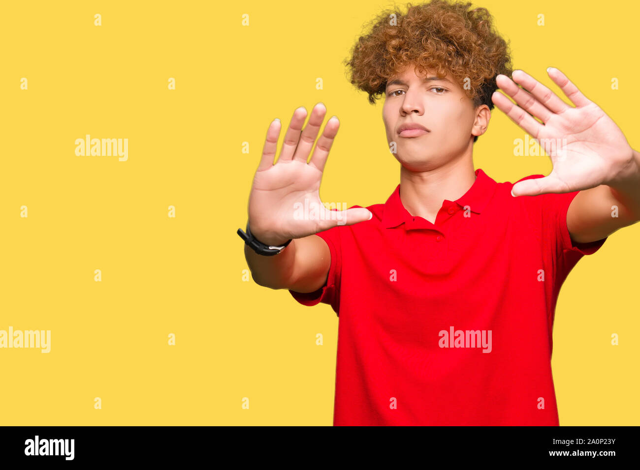 Young handsome man with afro hair wearing red t-shirt Smiling doing ...