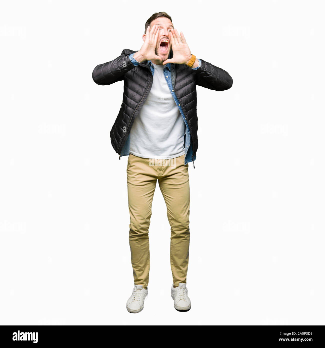 Handsome man wearing winter coat Shouting angry out loud with hands ...