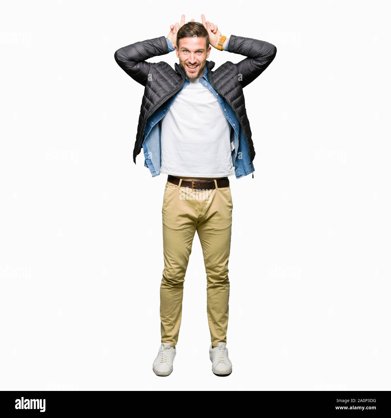 Handsome man wearing winter coat Posing funny and crazy with fingers on ...