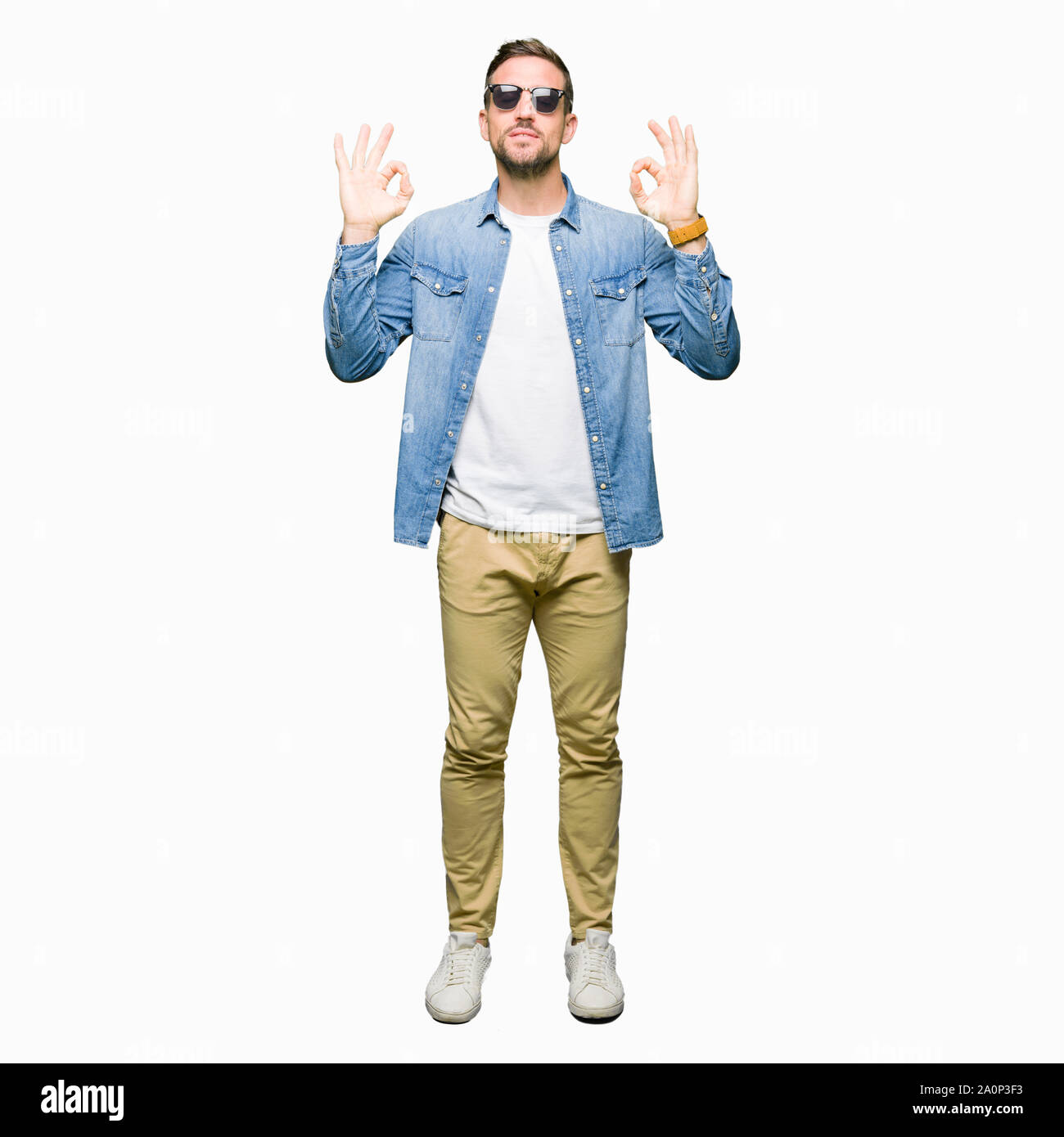 Handsome man wearing fashion sunglasses relax and smiling with eyes ...